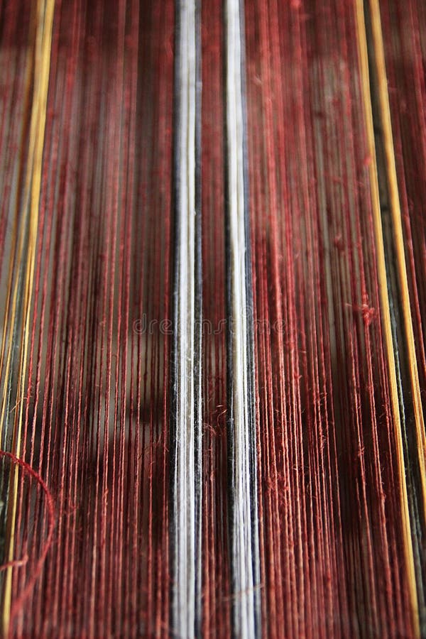 Red yarn on the loom. stock photo. Image of culture - 153259658