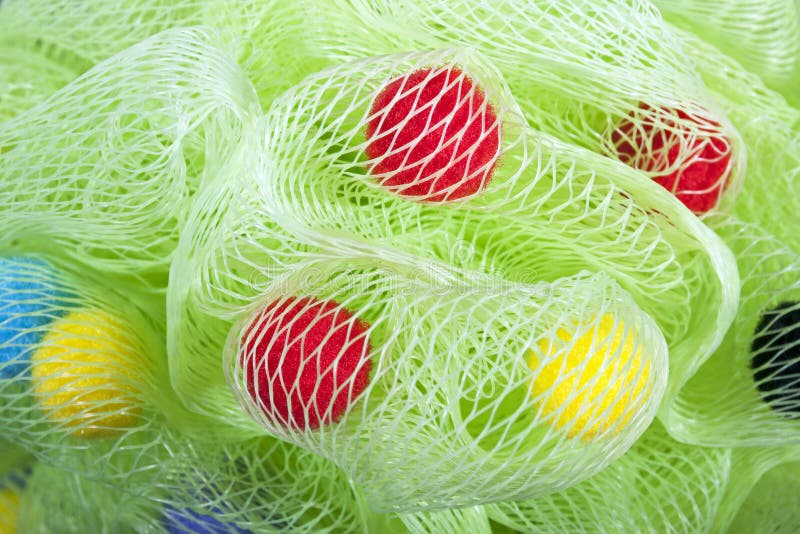 Red, Yellow and Blue Baubles in Green Bath Puff Stock Image - Image of ...