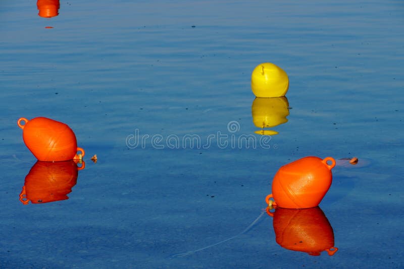 A Red and Yellow Buoy Floats on the Surface of the Sea Stock Photo ...