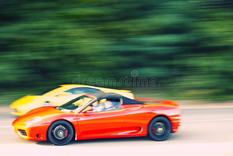 Red and Yellow Car Driving Fast on Country Road Editorial Photo - Image ...