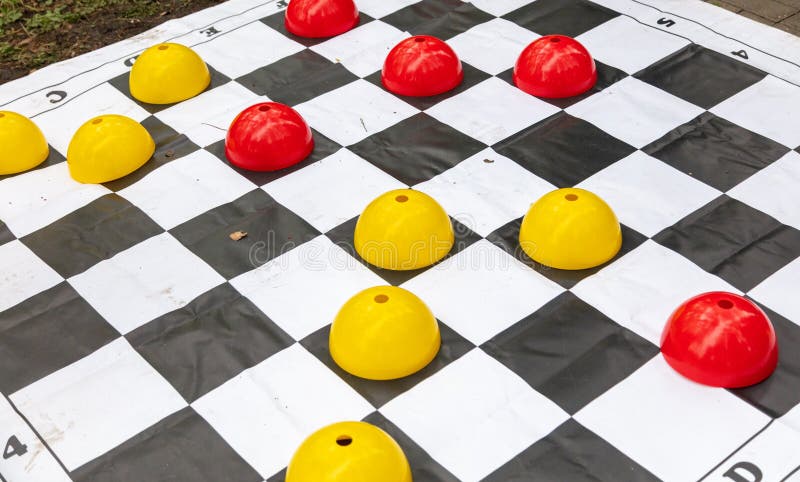 Red and Yellow Checkers in the Park. Stock Photo - Image of hand, fall ...
