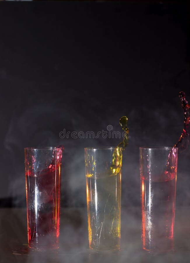 Red and Yellow Drink Glasses with Fog Stock Photo - Image of garnish ...