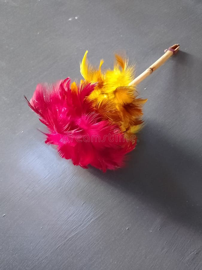 A Red and Yellow Duster Hangs on the Wall As a Backdrop Stock Photo ...