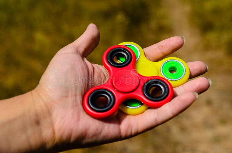Yellow Fidget Spinner on Wooden Desk Stock Image - Image of closeup ...
