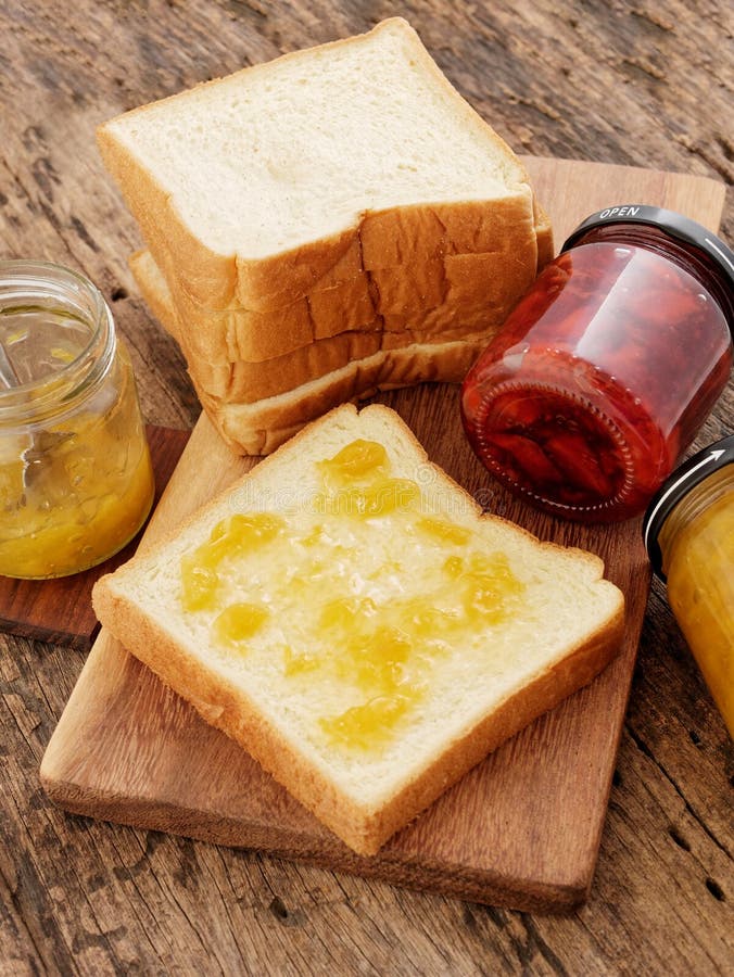 Red and Yellow Jam on Plank Wood and Slice Bread. Stock Image - Image ...