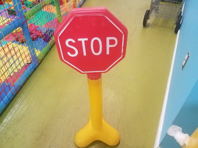Red and Yellow Plastic Stop Sign Stock Image - Image of sign, floor ...