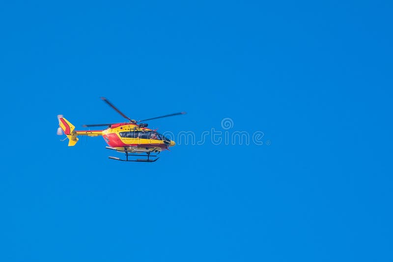 Red and Yellow Rescue Helicopter Moving in Blue Sky with Blur Pr Stock ...