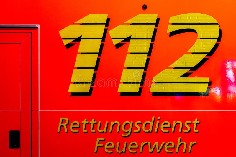 A Red and Yellow Sign with the Number 112 on it Stock Photo - Image of ...