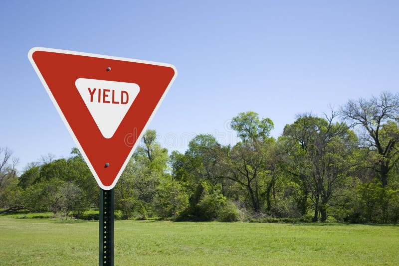 Red Yield Sign in a Green Landscape, Blue Sky Stock Image - Image of ...