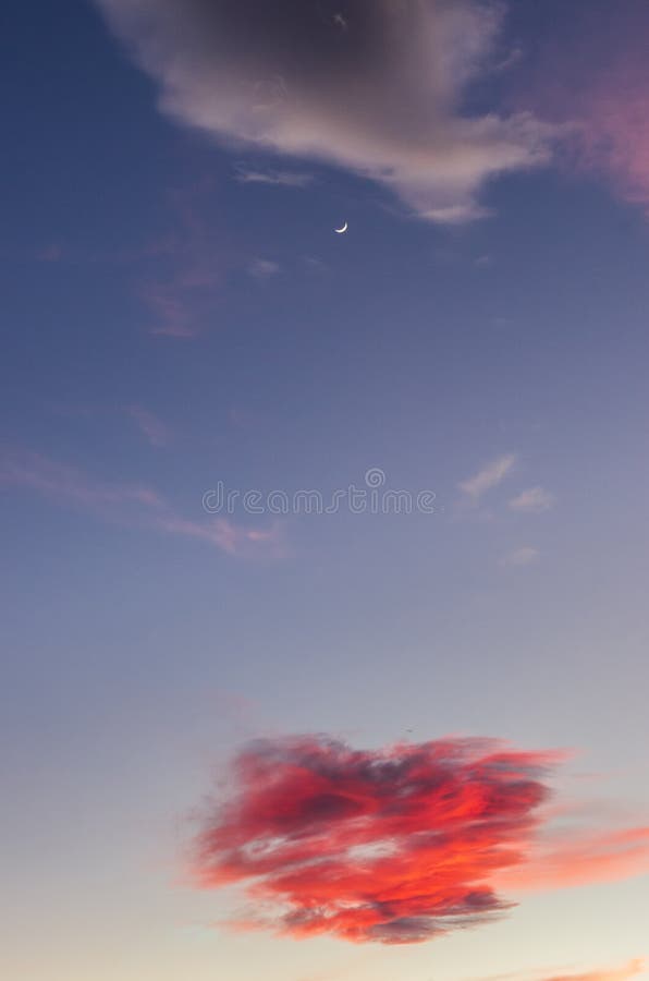 Reddish Clouds and the Moon at Sunset Over Mountains Stock Photo ...