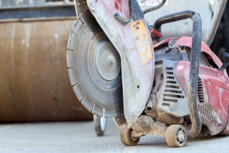 .a Reddish and Gray Concrete or Asphalt Cutter with a Large Metal Blade ...