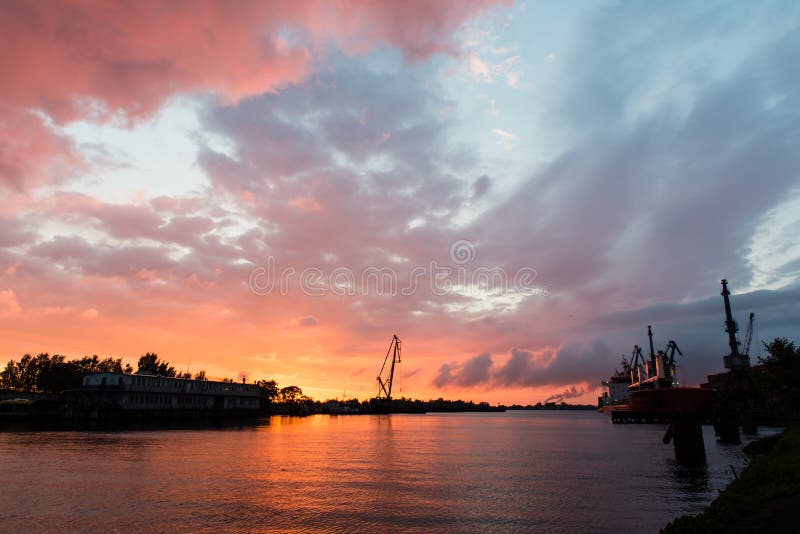 Reddish sunset over port stock photo. Image of orange - 55596272