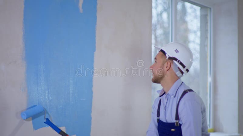 Male Master Painter Paints Walls by Hand Using Roller during Home ...
