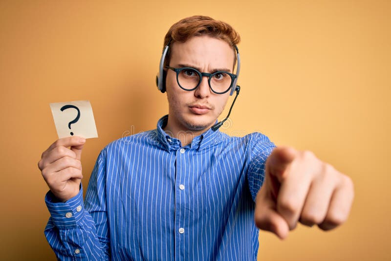 Redhead Call Center Agent Man Working Using Headset Holding Reminder ...