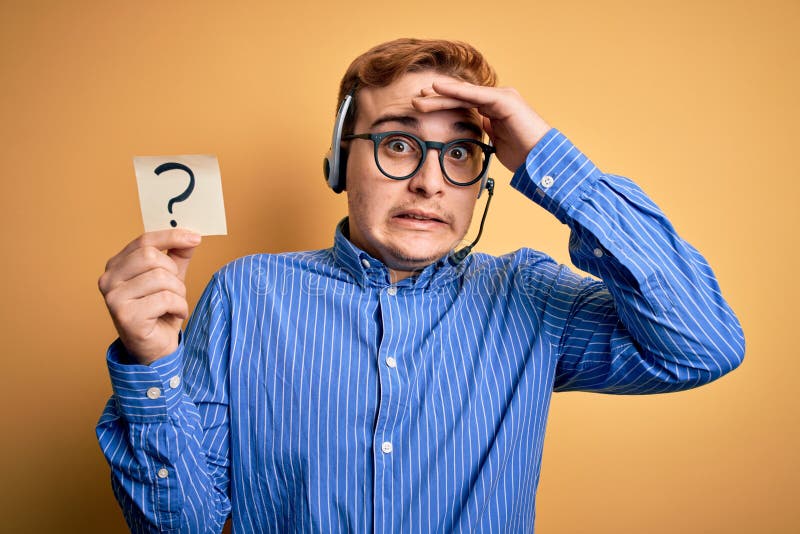 Redhead Call Center Agent Man Working Using Headset Holding Reminder ...