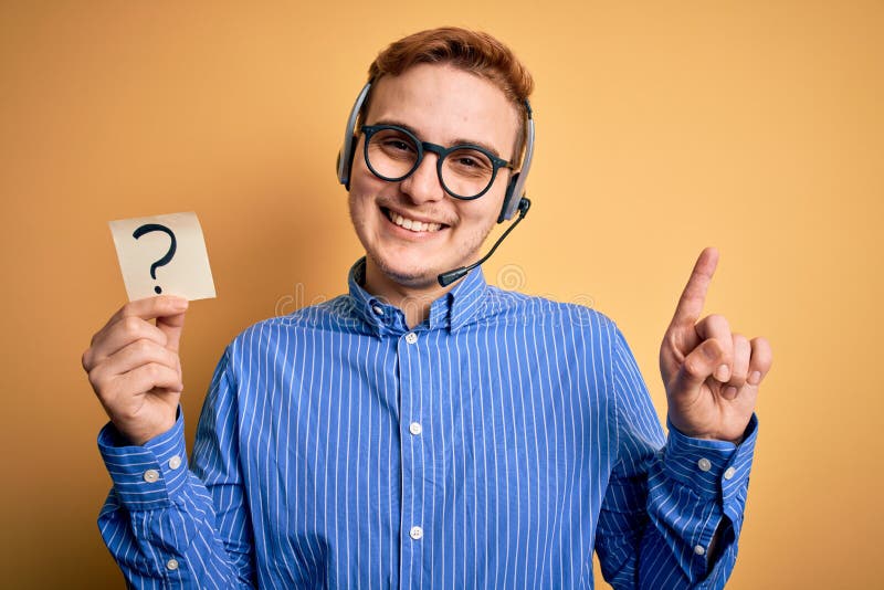 Redhead Call Center Agent Man Working Using Headset Holding Reminder ...