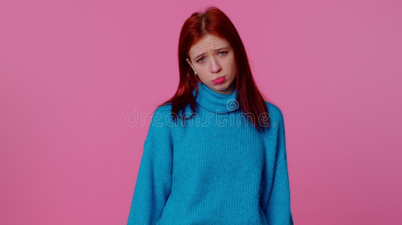 Redhead Cute Woman in Sweater Showing a Little Bit Gesture with Sceptic ... Redhead Cute Woman in Sweater Showing a Little Bit Gesture with Sceptic ...