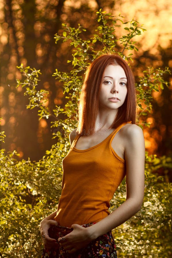Redhead Girl Walking Under Sunset Rays in Forest Stock Image - Image of ...