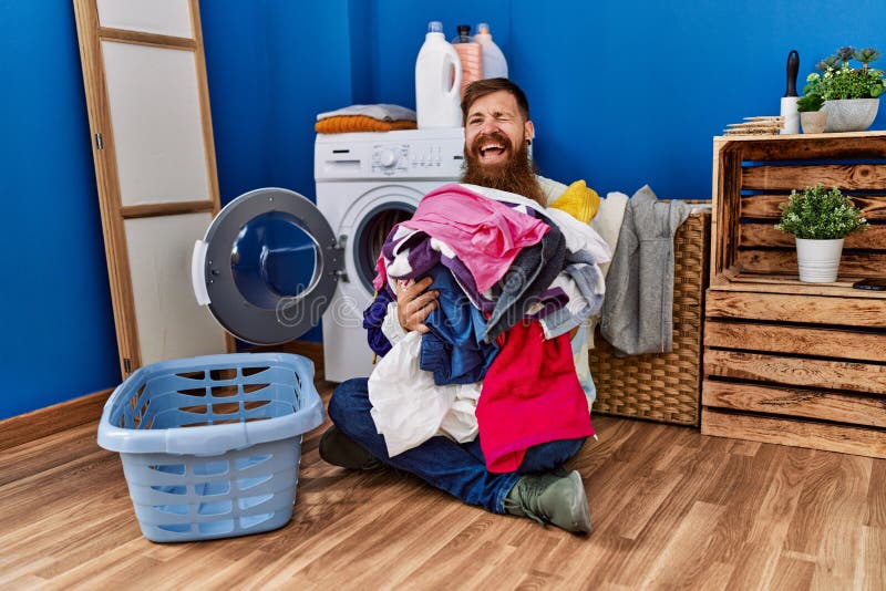 Redhead Man with Long Beard Putting Dirty Laundry into Washing Machine ...
