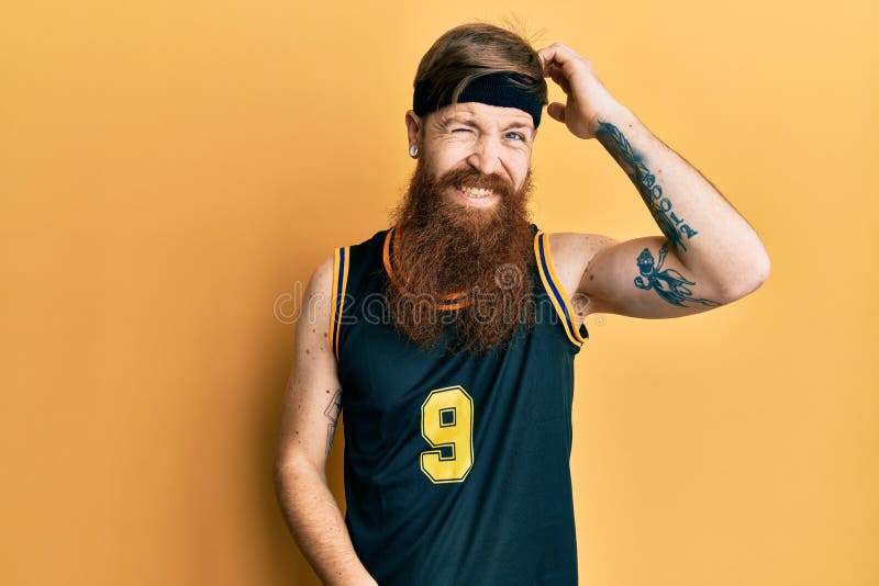 Redhead Man With Long Beard Wearing Basketball Uniform Confuse And