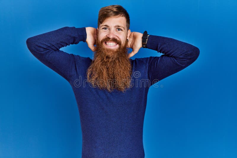 Redhead Man With Long Beard Wearing Casual Blue Sweater Over Blue