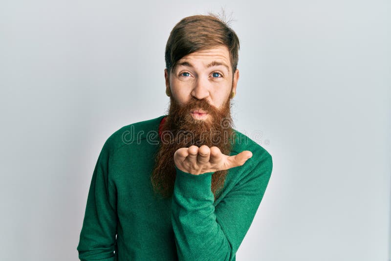 Redhead Man With Long Beard Wearing Casual Clothes Looking At The