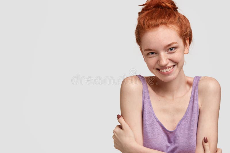 Redhead Shy Woman With Freckled Skin Has Gentle Smile Keeps Hands
