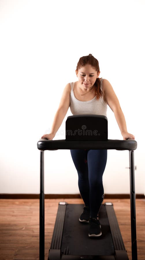Redhead Woman Doing Exercises on a Treadmill, Front View Stock Image ...