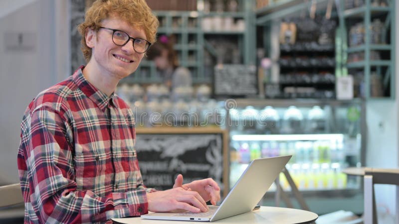 Redhead Young Man with Laptop Smiling at the Camera Stock Photo - Image ...
