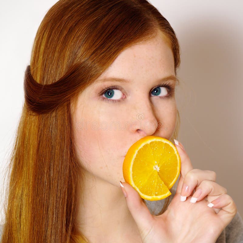 Redheaded girl with orange stock image. Image of female - 10998499