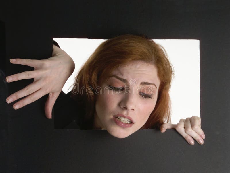 Redheaded Woman Climbing Out of a Black Box Stock Image - Image of ...