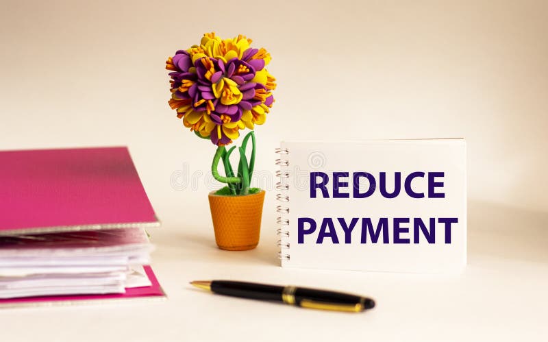 REDUCE PAYMENT Text on Notepad in Front of Document Folder, Pen Stock ...