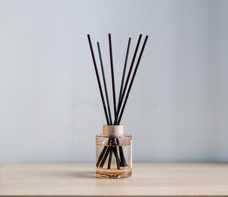 Reed Diffuser in Glass Bottle Placed on Wood Table Against White Wall ...