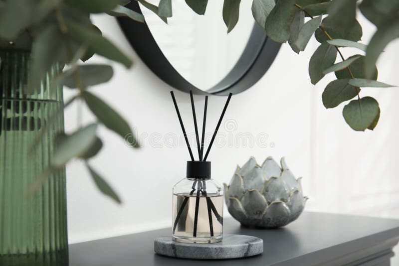 Reed Diffuser and Home Decor on Grey Table Near White Wall Stock Photo ...