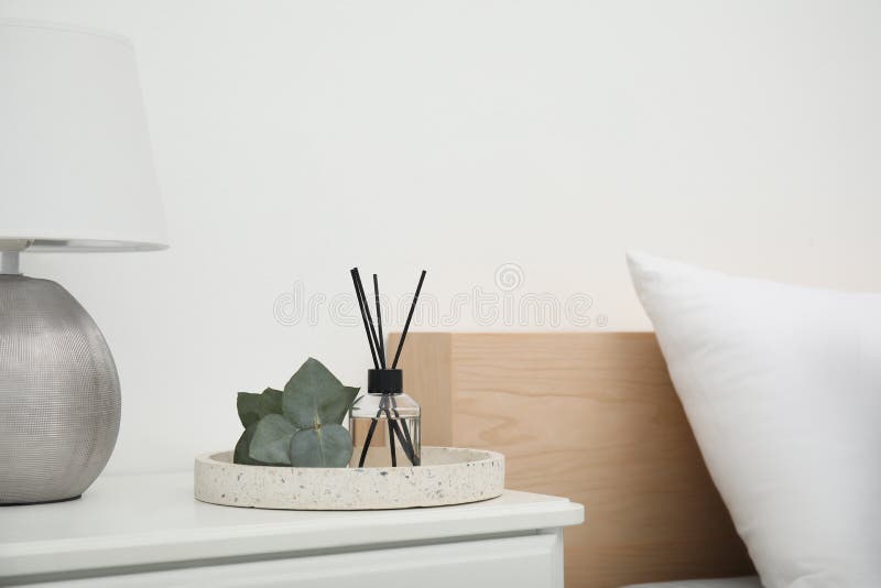 Reed Diffuser with Lamp and Eucalyptus on Nightstand in Bedroom Stock ...