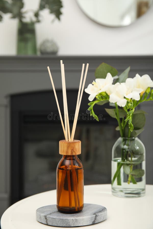 Reed Diffuser and Vase with Bouquet on White Table in Room Stock Photo ...