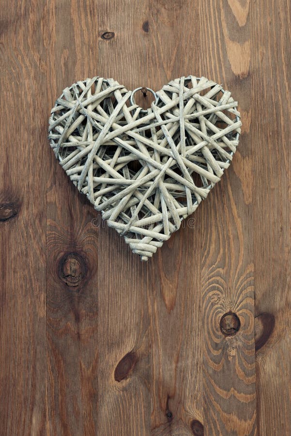Reed Heart Hanging Against a Rustic Wooden Background. Stock Photo ...