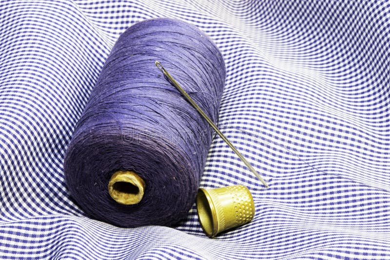 Reel of Thread, Needle and Thimble on a Piece of Cloth Stock Image ...