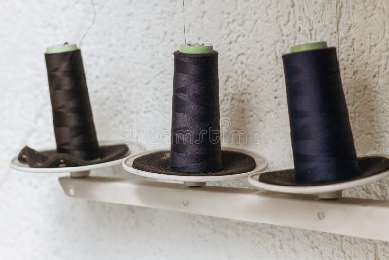 Reels with Black Threads for a Sewing Machine on a Stand in Atelier ...