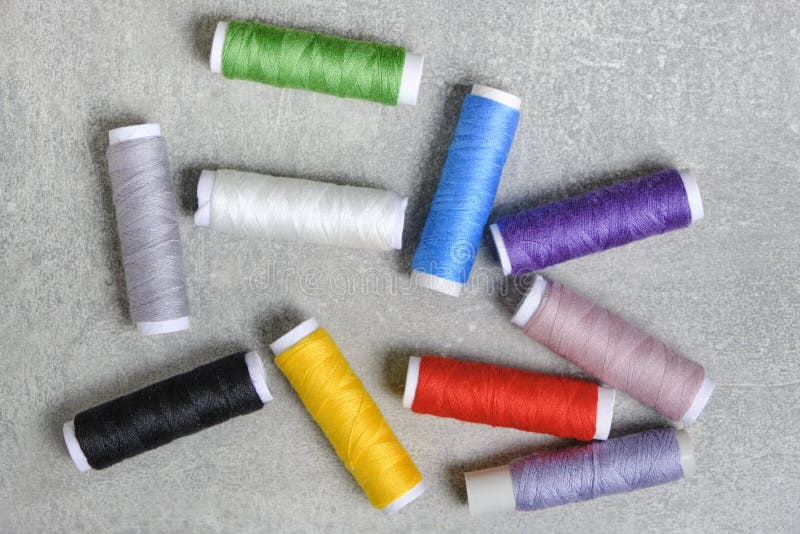 Reels with Multi Colored Sewing Threads Gray Concrete Background. Stock ...
