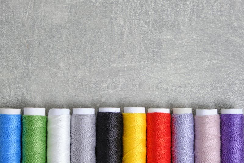 Reels with Multi Colored Sewing Threads Gray Concrete Background. Stock ...
