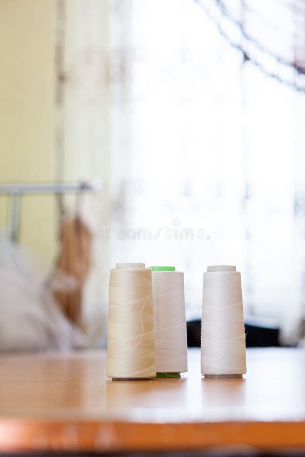 Reels with White Threads for a Sewing Machine on a Stand in Atelier ...