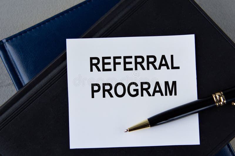 REFERRAL PROGRAM - Words on White Sheet on a Black Leather Book with ...