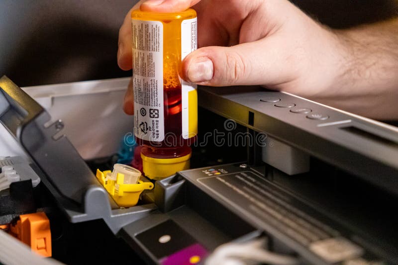 Refilling Yellow Ink Tank in Printer during Maintenance To Ensure ...