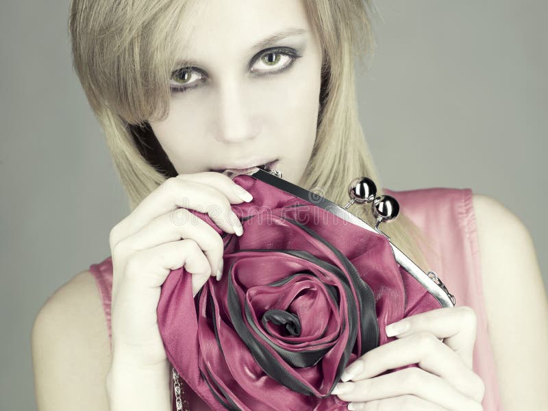 Refined Young Woman in a Blue Dress Sitting Against a Rose Garden and ...