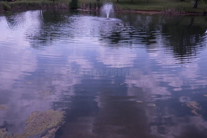 Reflecting Pond with Clouds and Water Fountain Stock Image - Image of ...