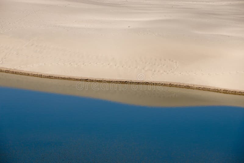 Reflecting Sand Dune in Blue Lagoon Water Stock Image - Image of water ...