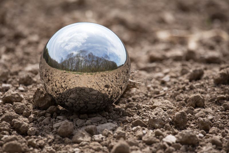 Reflecting Sphere on Brown Earth Stock Image - Image of geometric ...