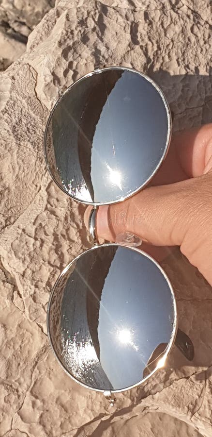 Reflecting Sun Glasses on a Rock in the Beach Stock Photo - Image of ...