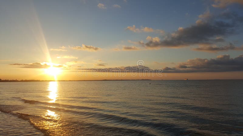 Reflecting Sunset on the Ocean with the Tide Coming in. Stock Image ...
